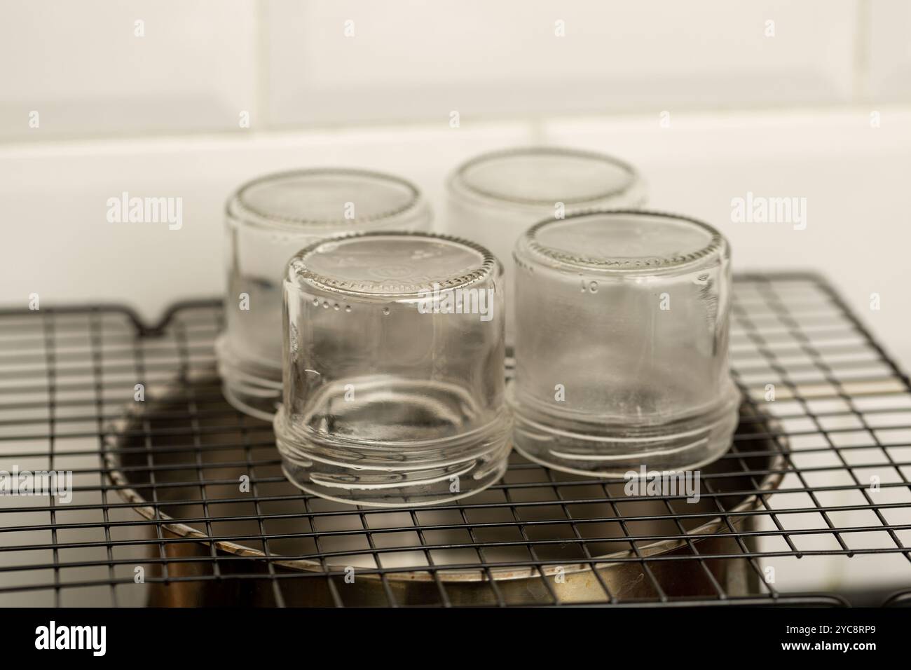 Glass jars over a stainless steel pan during steam sterilization for ...