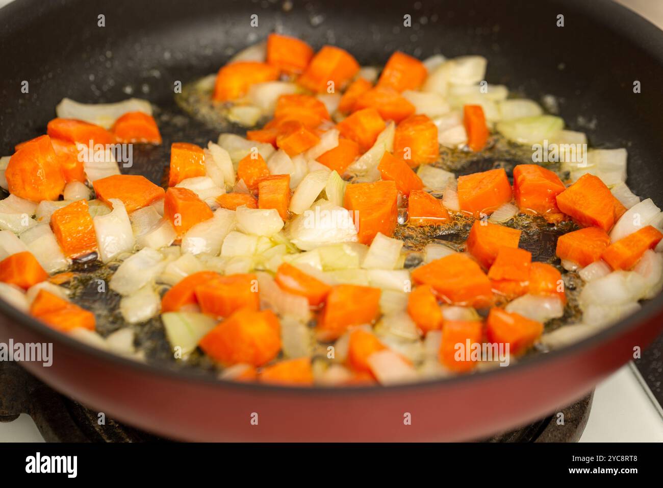 Finely chopped onions and fresh carrots are fried in butter, pate ...