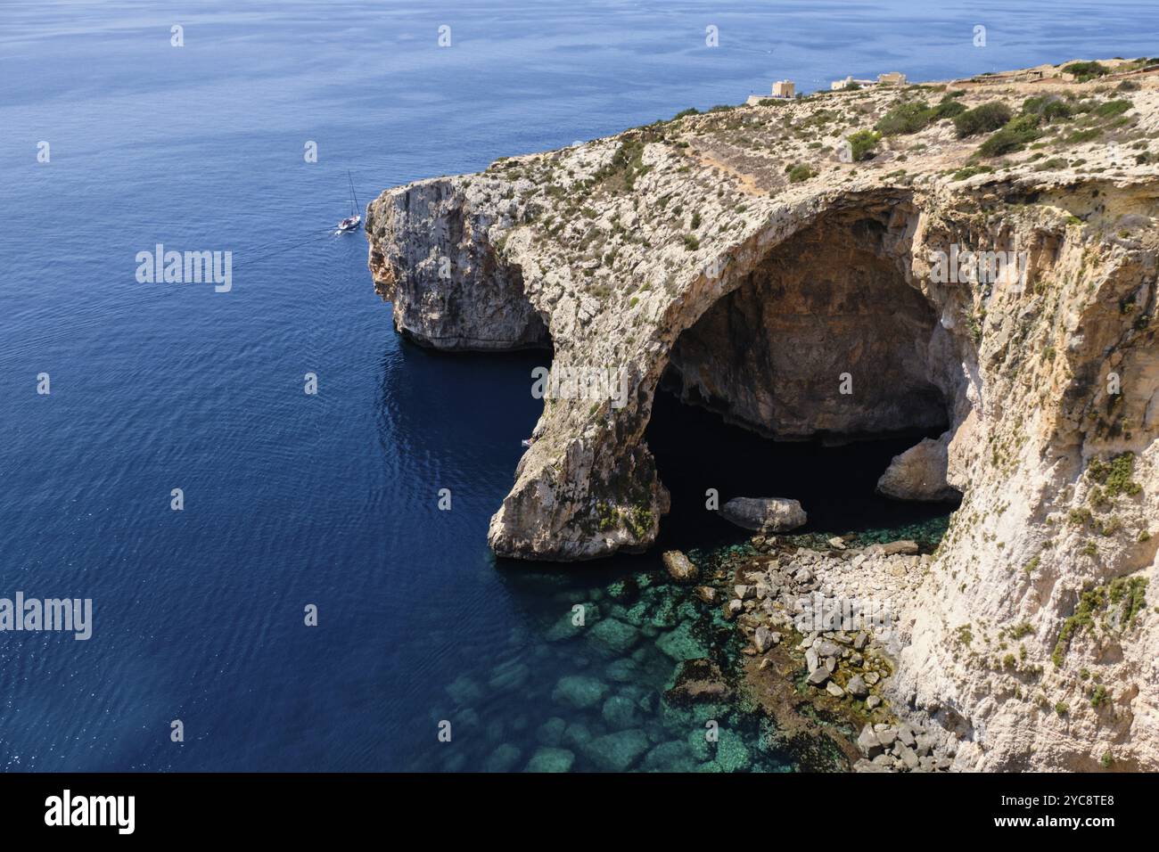 The natural arch of the Blue Grotto photographed from the Blue Wall and ...