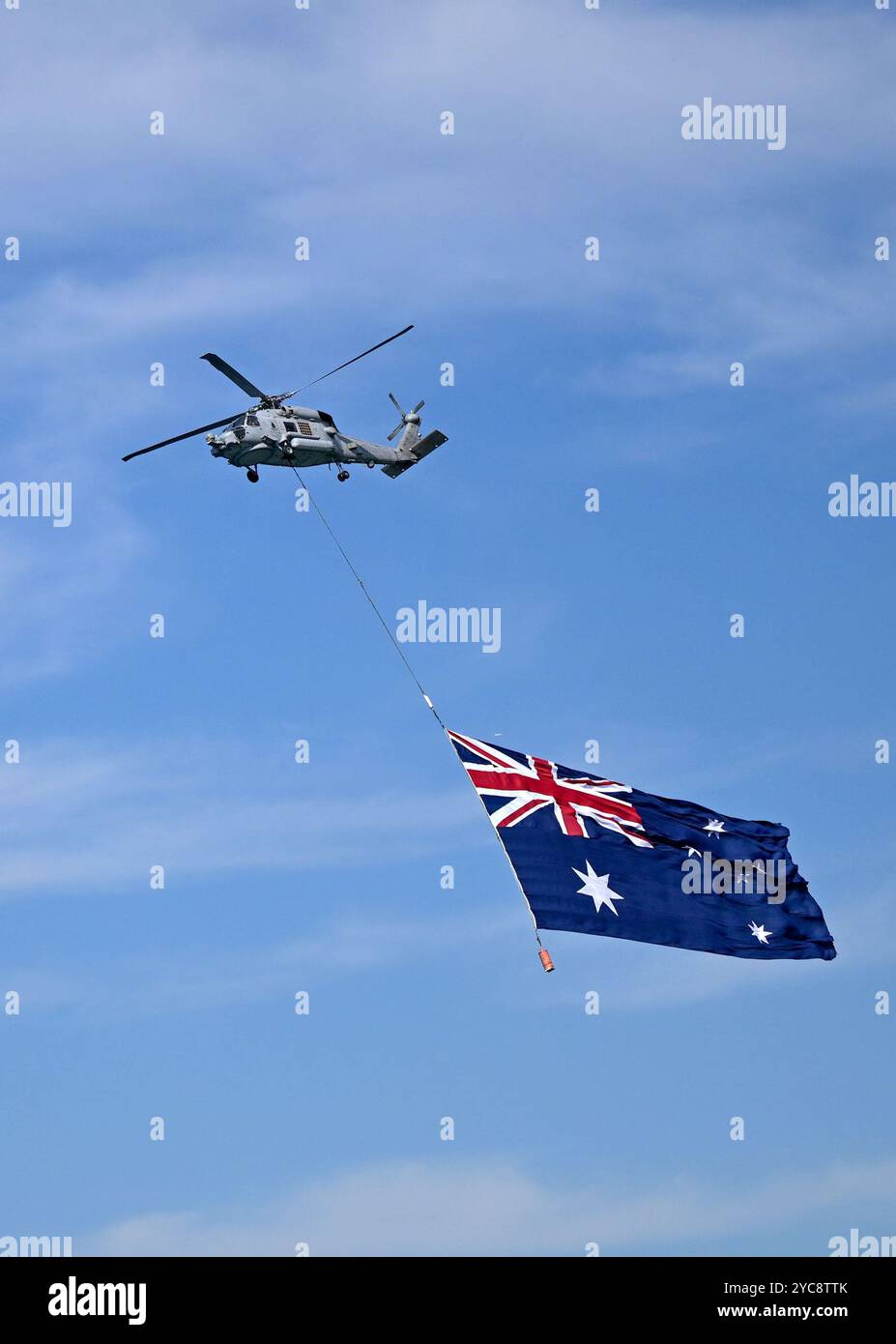A helicopter flying the Australian flag flies over Sydney Harbour ahead ...