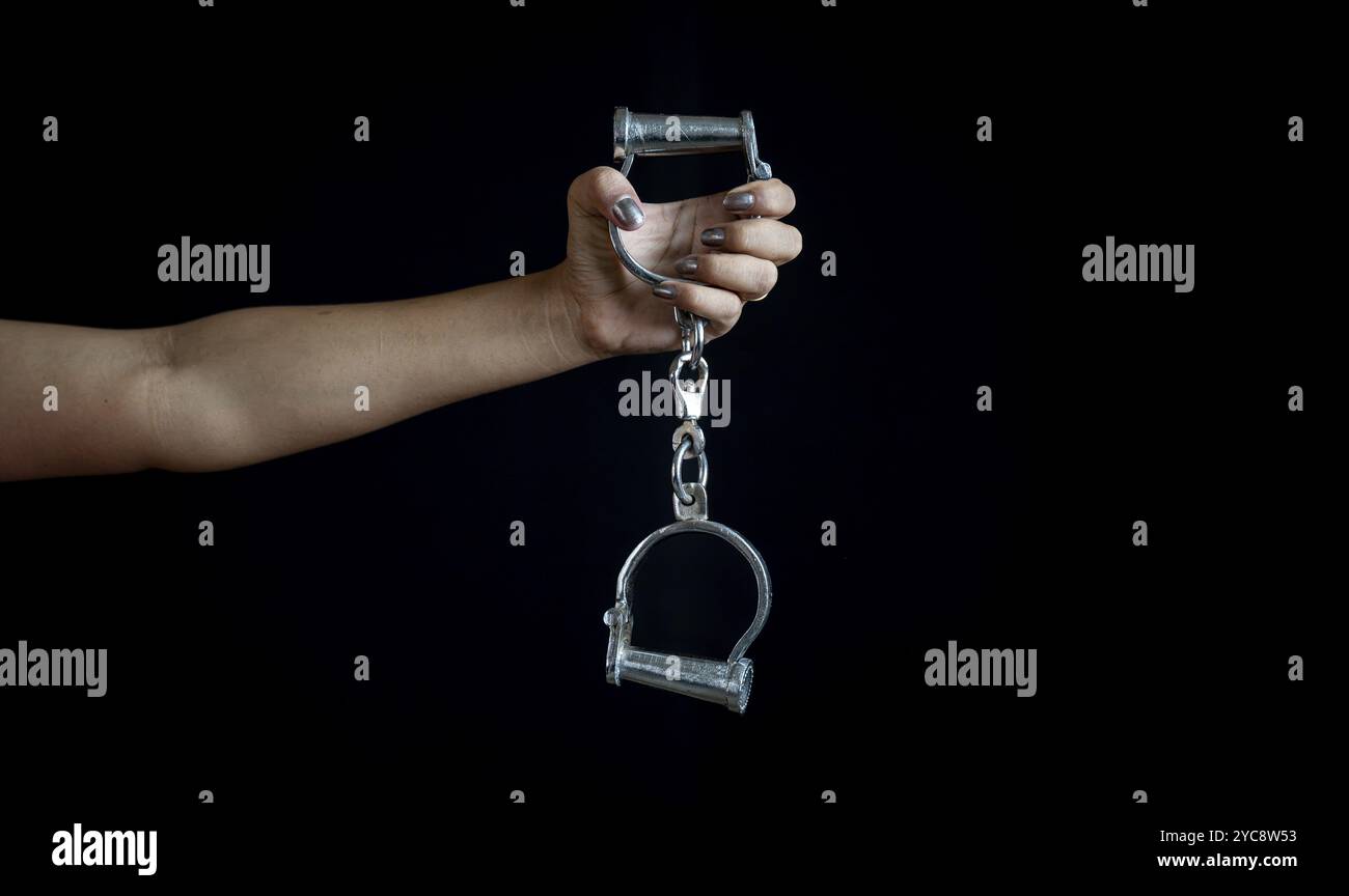 Woman hands in handcuffs- concept image Stock Photo - Alamy
