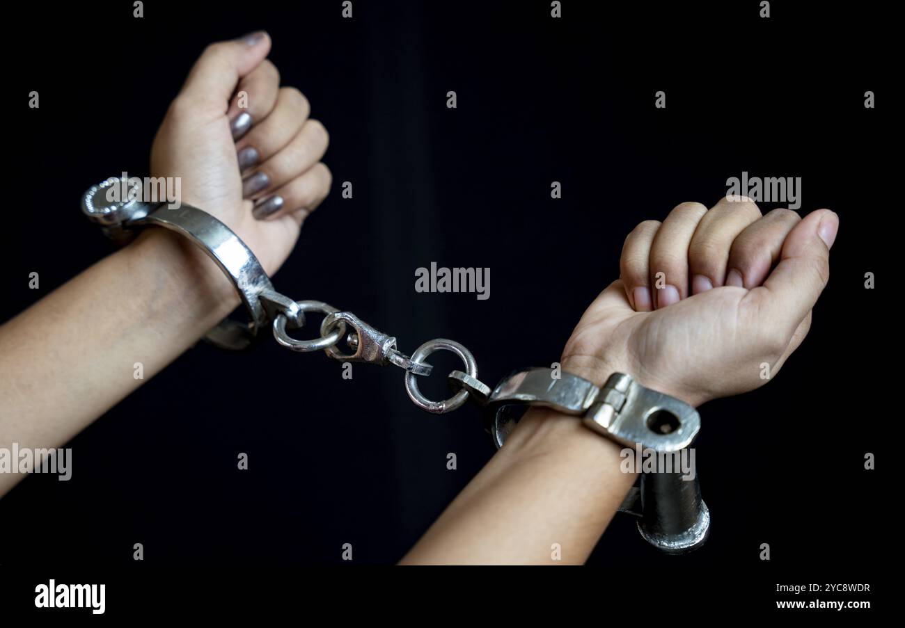 Woman hands in handcuffs- concept image Stock Photo - Alamy