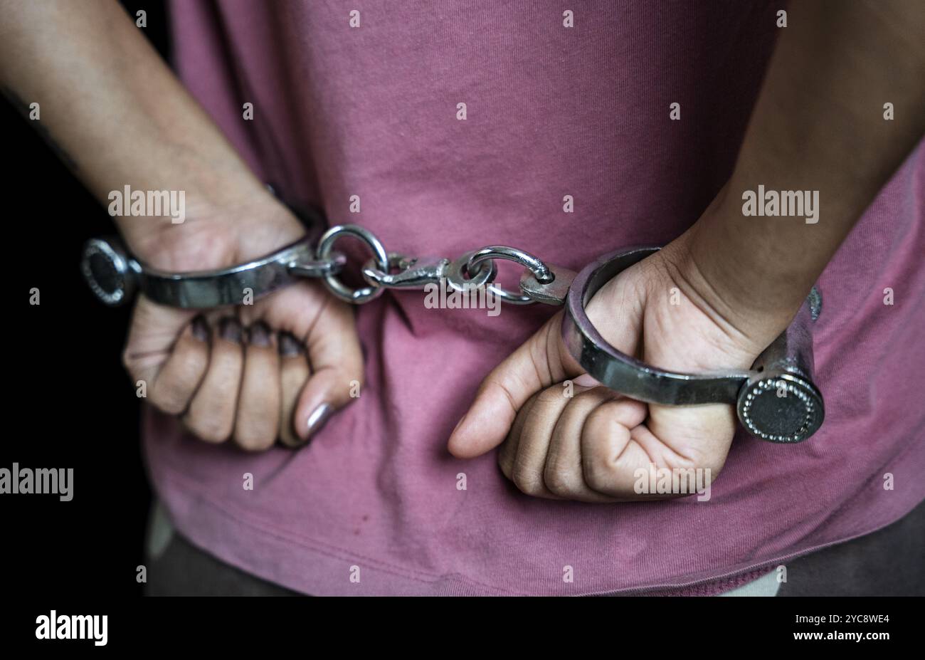 Woman hands and handcuffs hi-res stock photography and images - Alamy