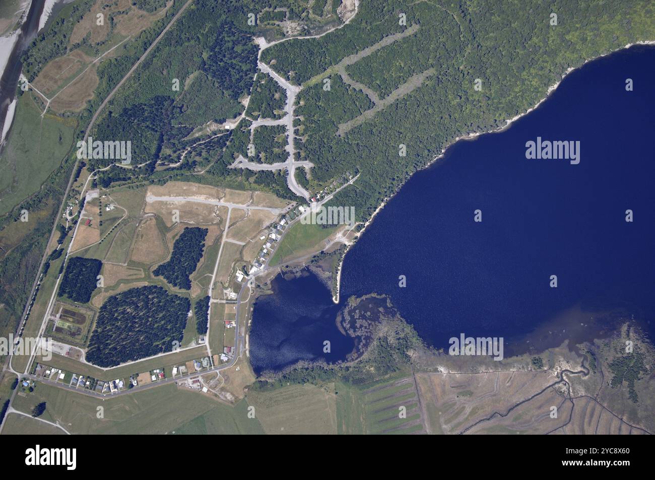 Aerial of Iveagh Bay housing development and Lake Brunner, West Coast ...