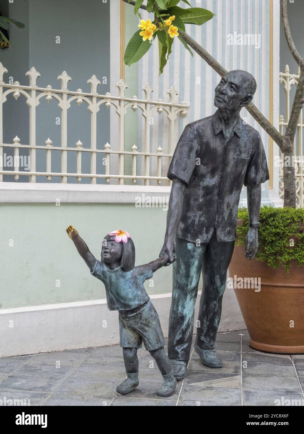 Bronze sculpture by Chern Lian Shan (2000) of an elderly man holding ...