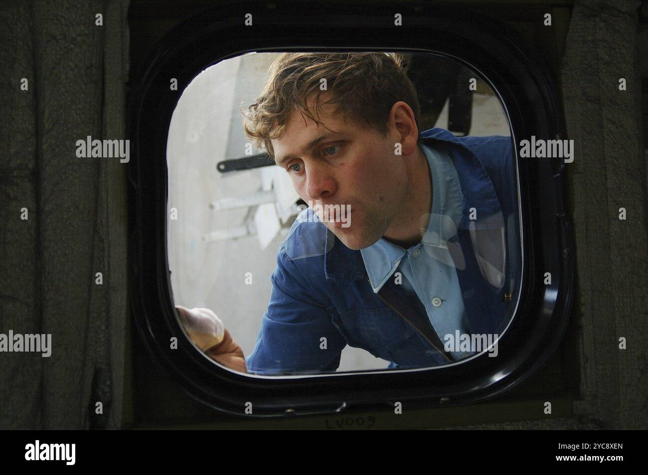 Tradesman cleaning newly installed aircraft windows Stock Photo - Alamy