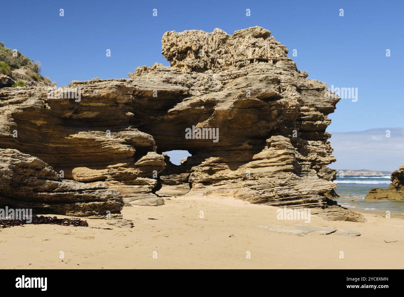 Scuptured sandstone rock formations on the beach below the lighthouse ...