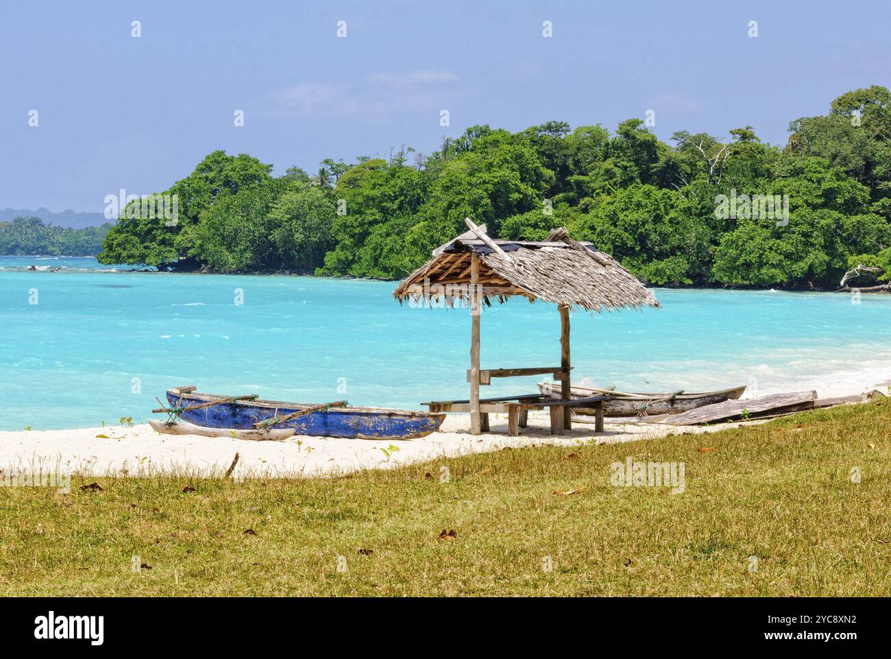 Outrigger canoes and a leaf beach bungalow at Olry Bay, Espiritu Santo ...