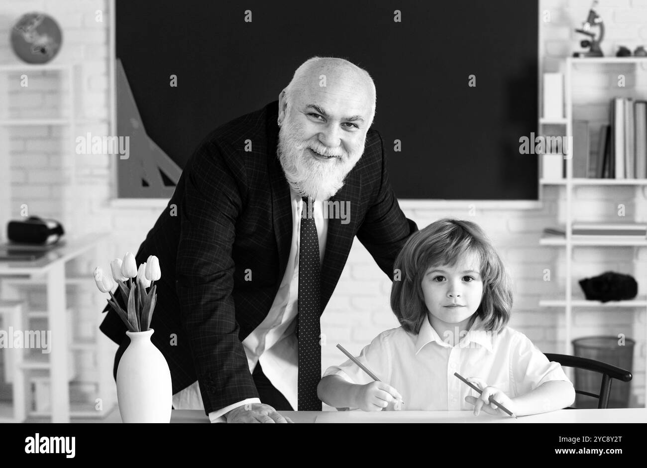 Professor or teacher teaching little student boy. Teacher is skilled ...