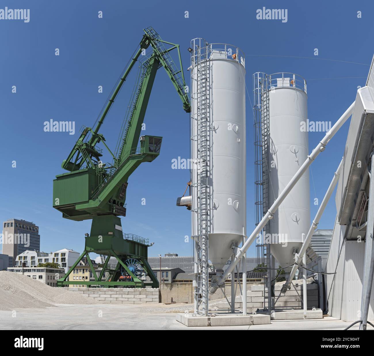 Exterior view of a cement factory with crane and concrete mixing silo ...