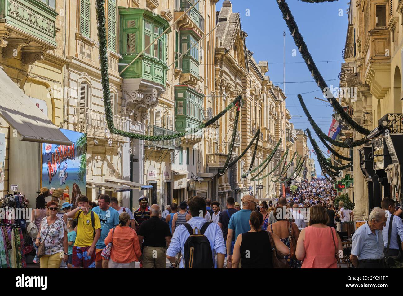 Tourists and locals walk along the Republic Street, the main street of ...