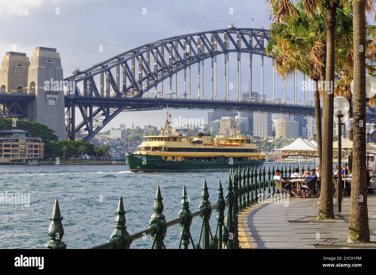 Harbour Bridge and a ferry boat arriving to Circular Quay, the main ...