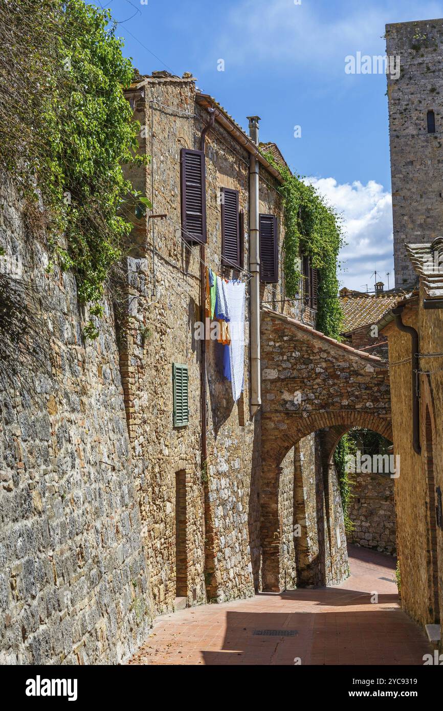 Old village with hanging laundry in a alley Stock Photo - Alamy