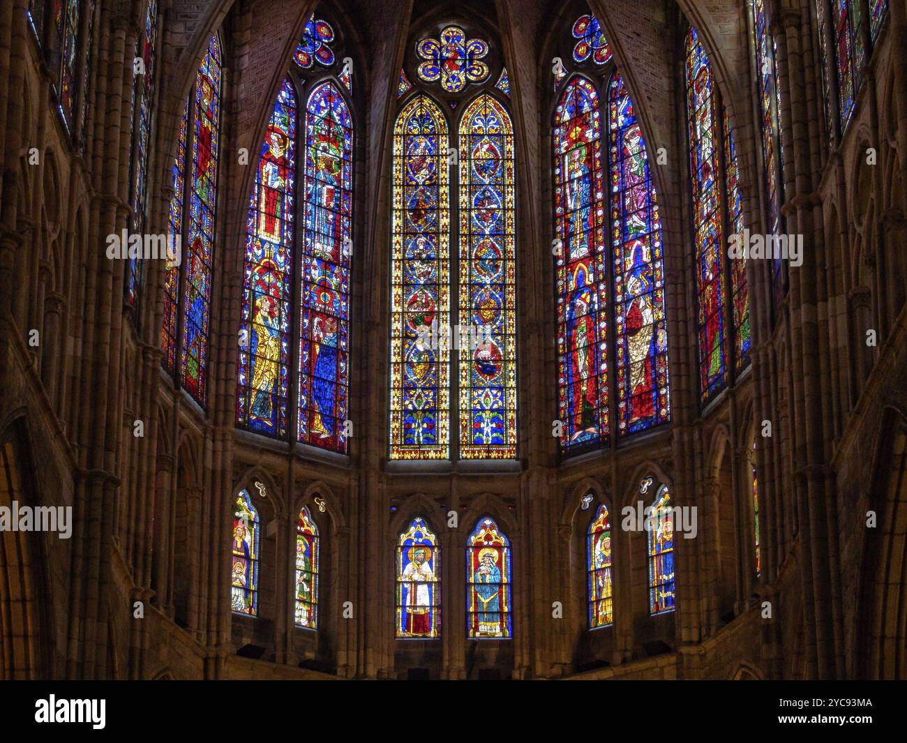 Stained glass windows above the main altar in the semicircular apse of ...