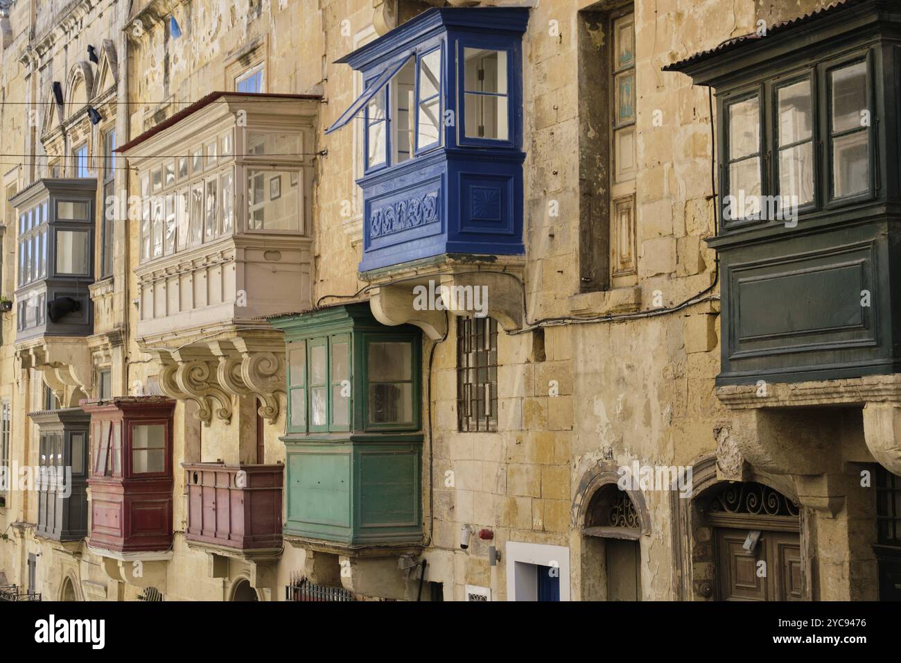 Traditional colourful enclosed wooden balconies, called gallariji, on ...