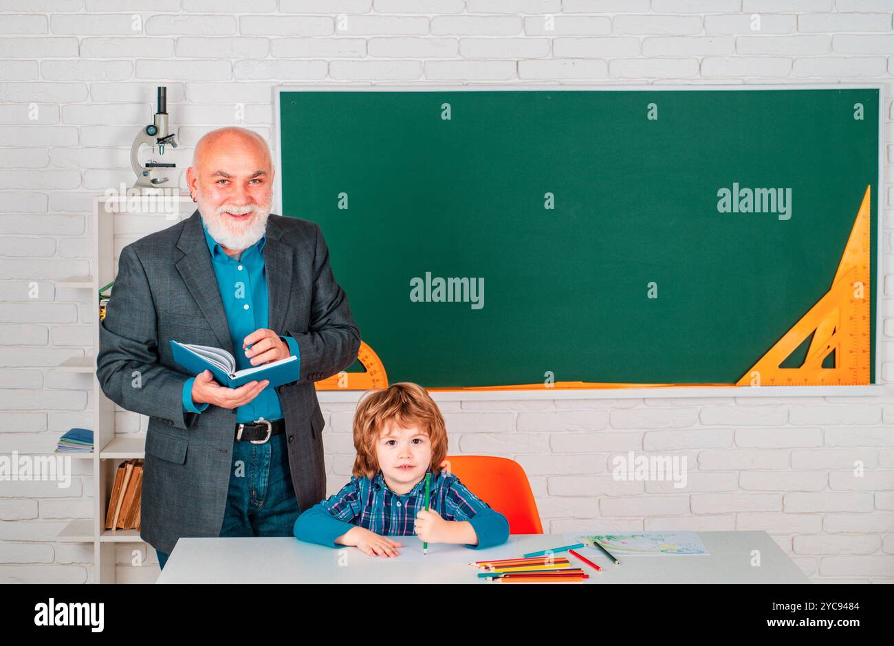 Child at school lesson with senior teacher. Senior teacher with pupil ...