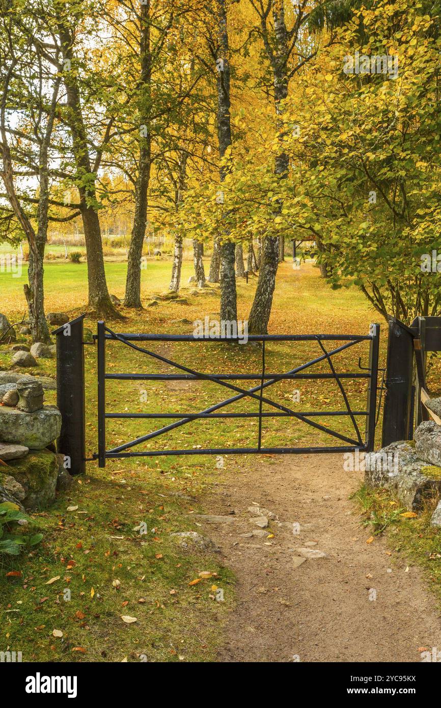 Closed gate in a garden in the fall Stock Photo - Alamy