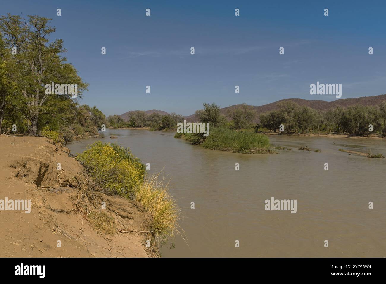 Landscape view of the Kunene River, the border river between Namibia ...