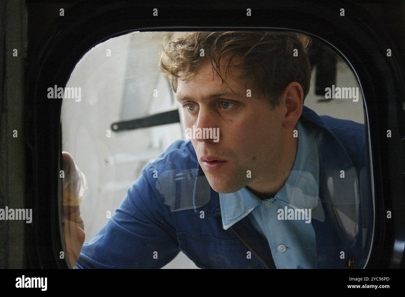 Tradesman cleaning newly installed aircraft windows Stock Photo - Alamy