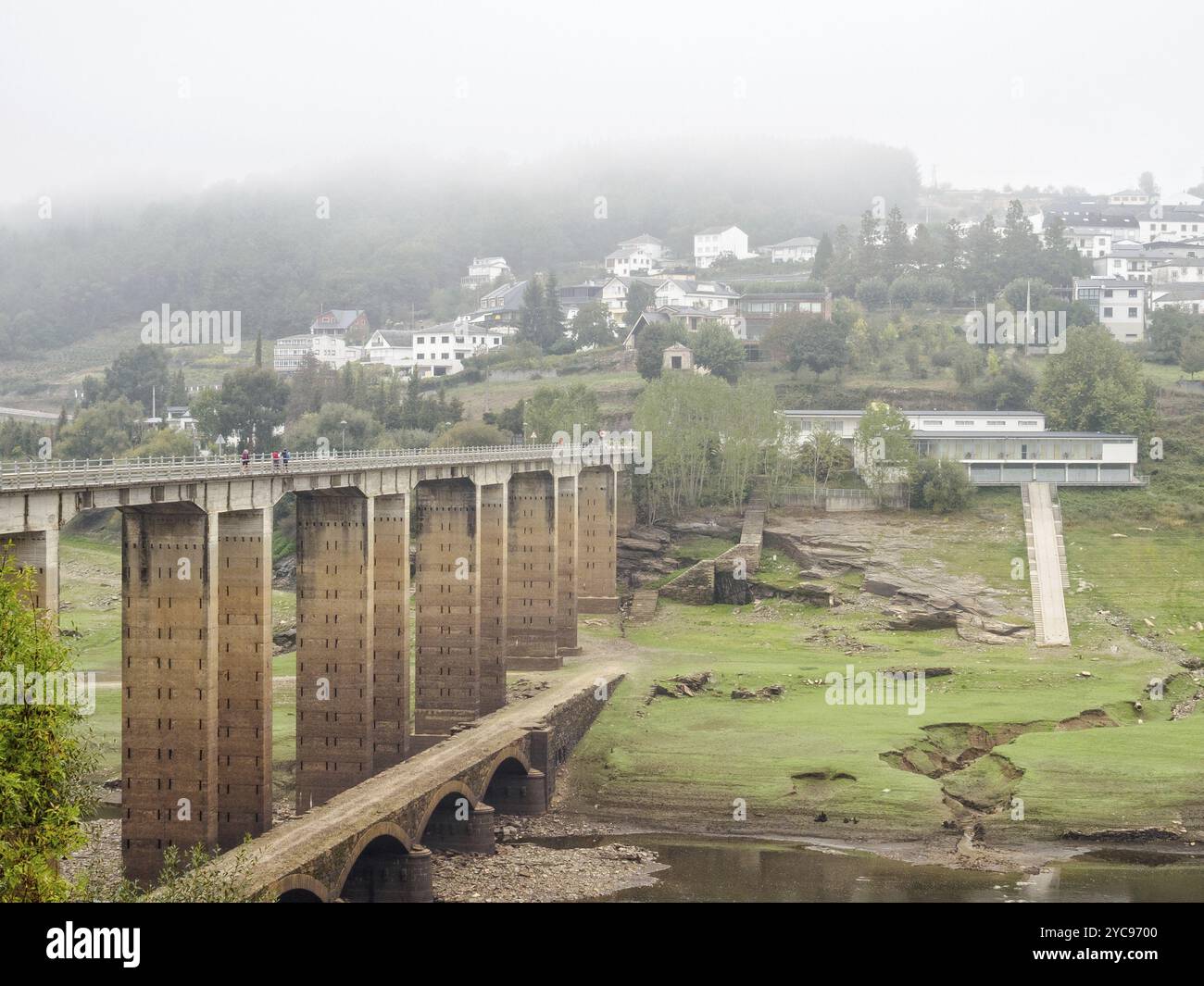 Camino pilgrims walk across the new bridge over the Minho River in a ...