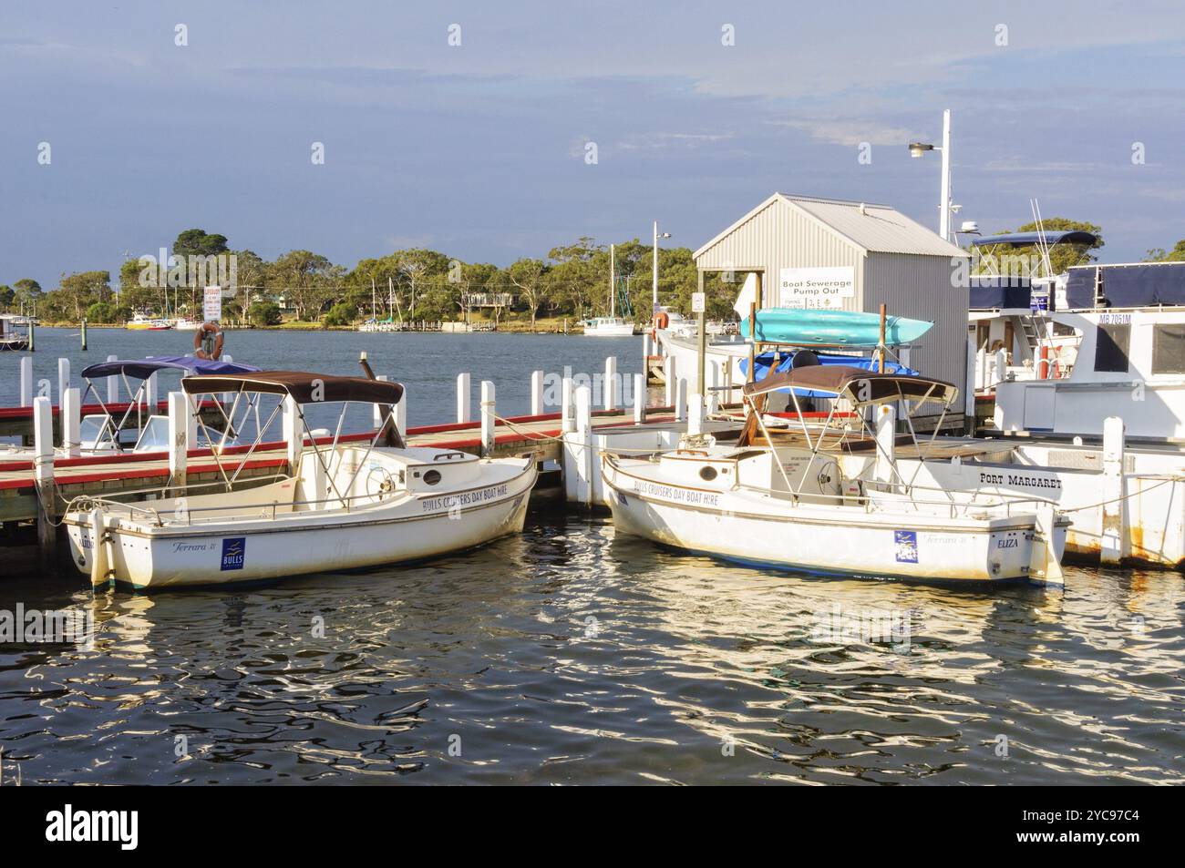 Boats for hire moored at a public jetty, Paynesville, Victoria ...