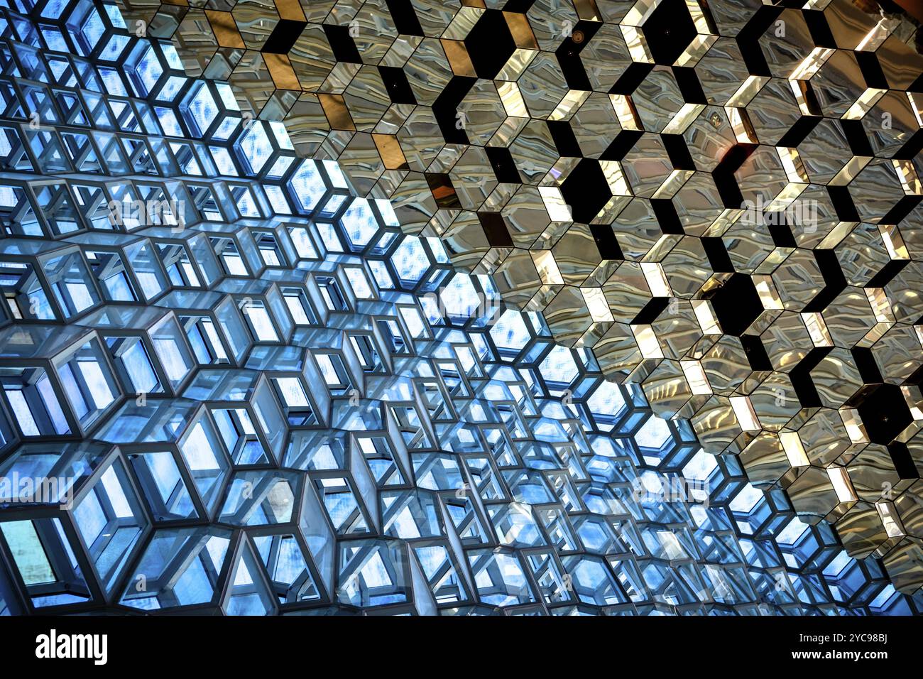 Compact geometric patterns in a glass architecture reflecting blue and ...