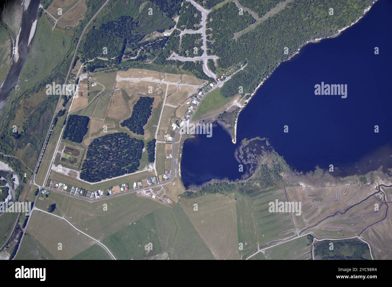 Aerial of Iveagh Bay housing development and Lake Brunner, West Coast ...