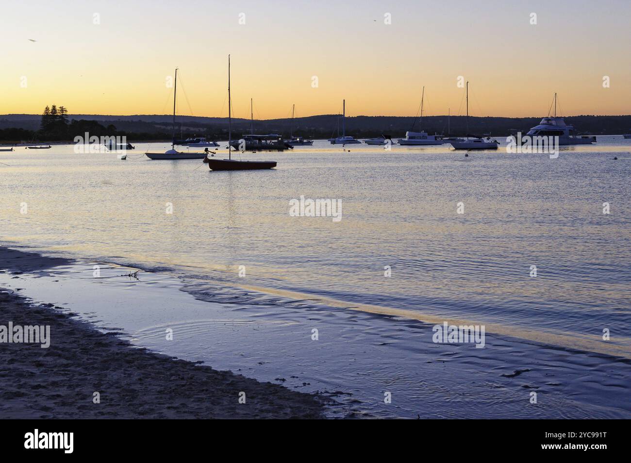 Yachts anchored in the bay at twilight, Dunsbrough, WA, Australia ...