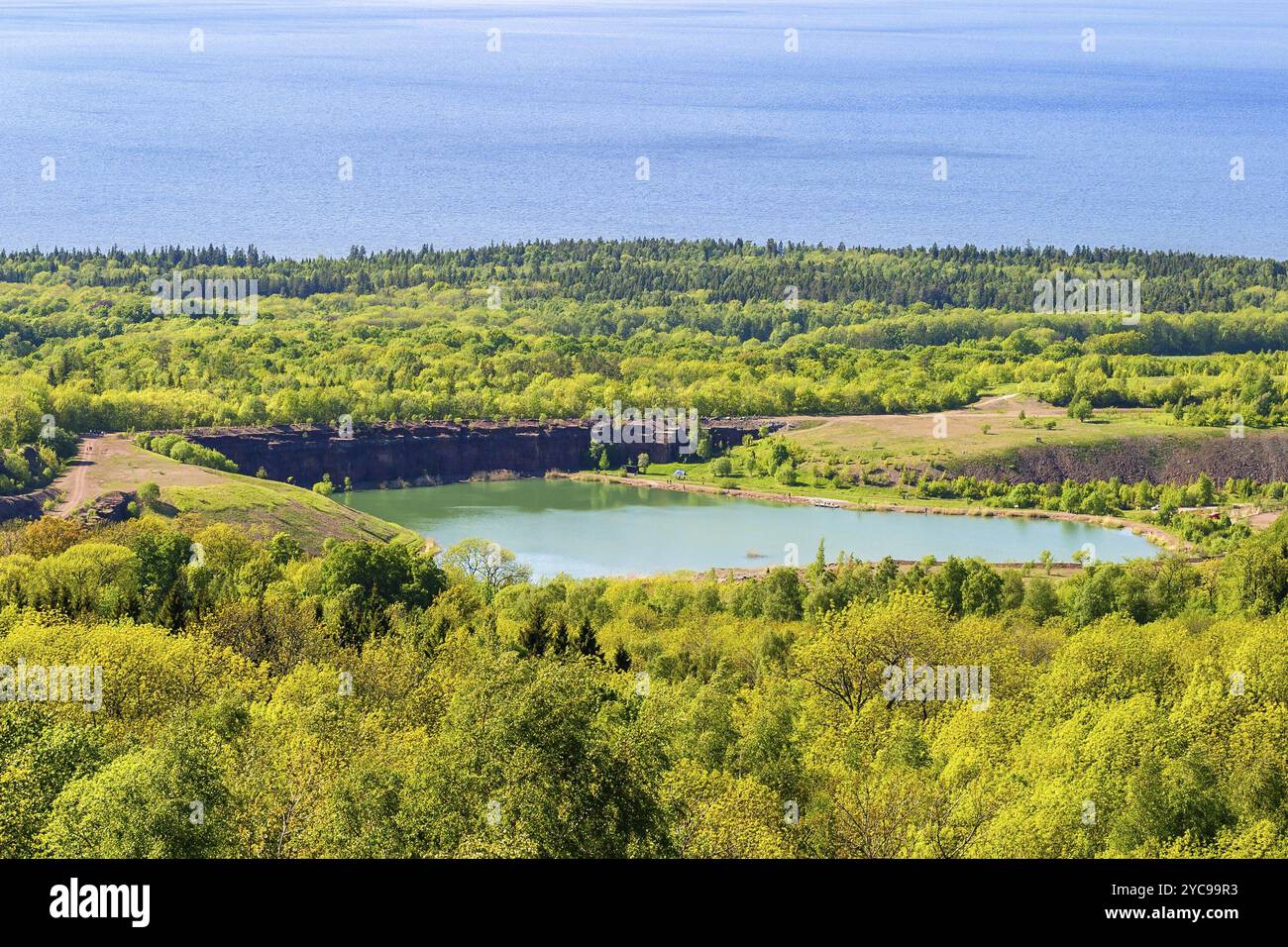 Old open pit with a lake and forest Stock Photo - Alamy