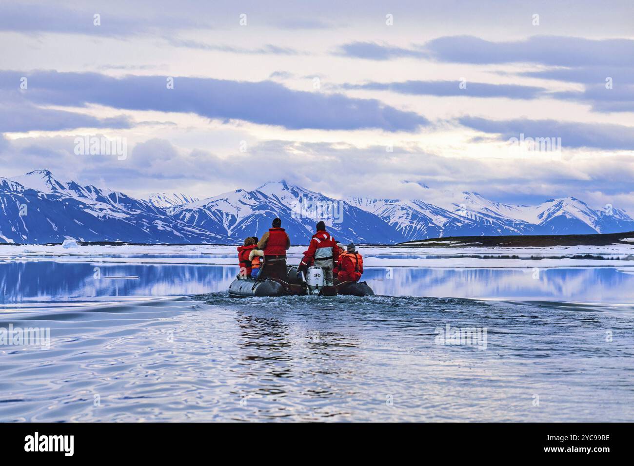 People travelling in inflatable boat at Svalbard Stock Photo - Alamy