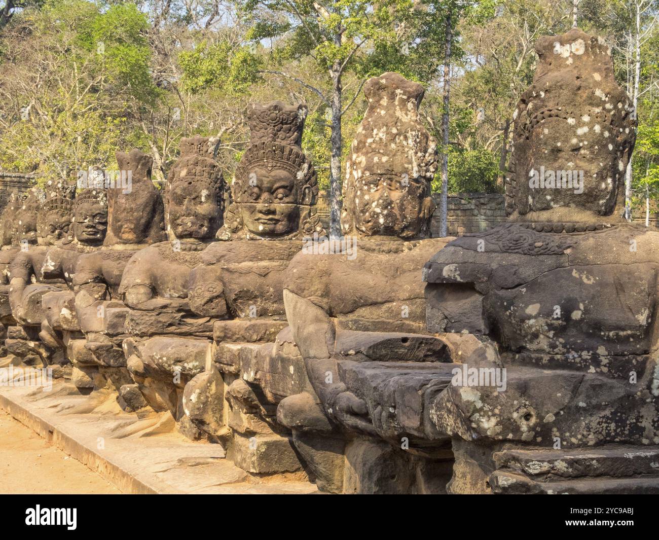 Statues of asuras (demons) at the South Gate of Angkor Thom, Siem Reap ...