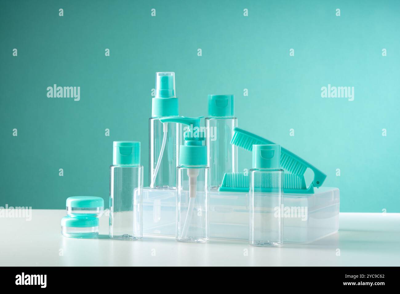 Clear containers for beauty products arranged on a white surface ...