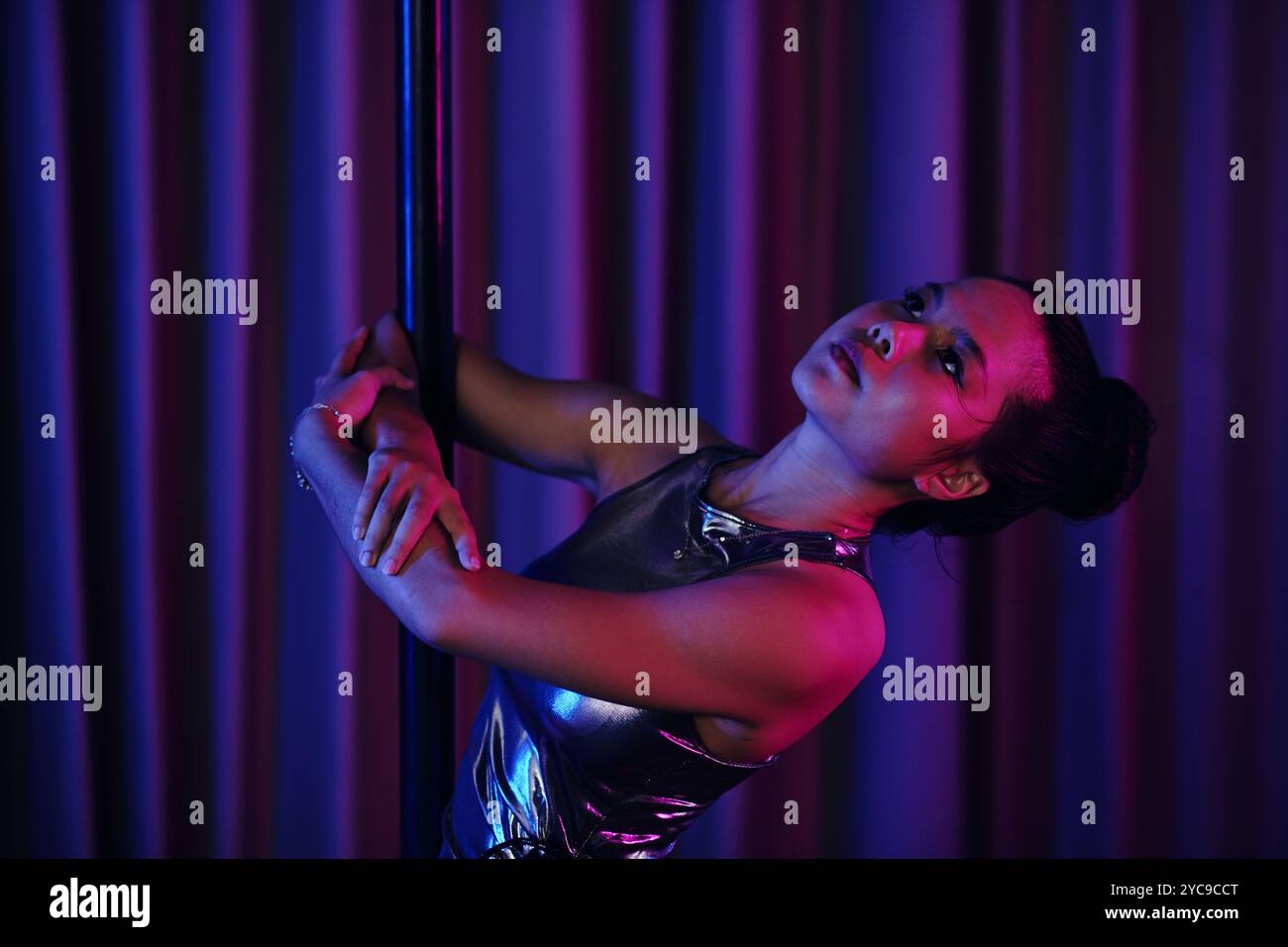 Twirling Around Pole with Dramatic Lighting Effects Stock Photo - Alamy