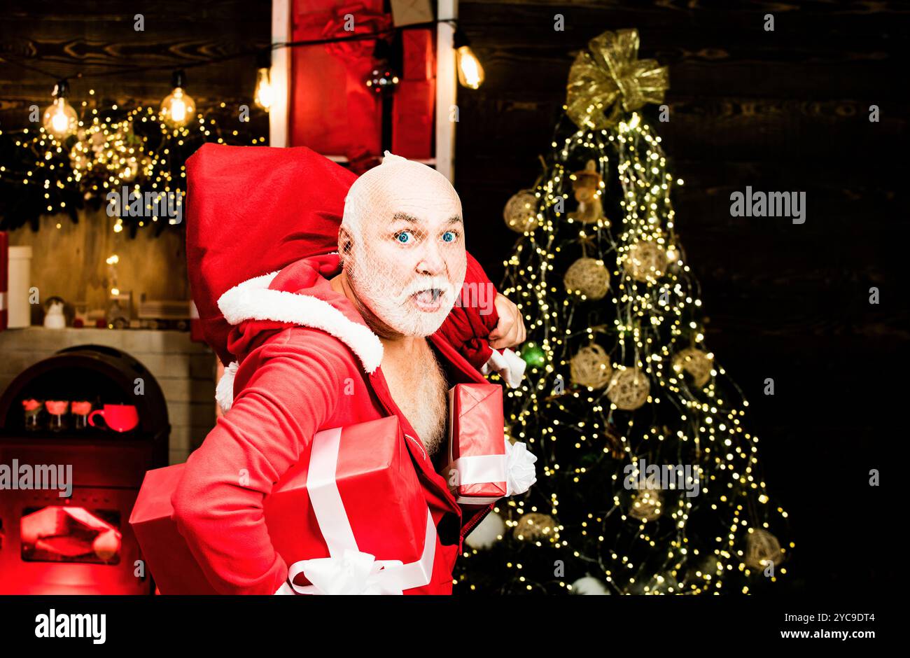 Burglar man dressed in Santa wearing a Santa hat. Thief Santa with bag ...