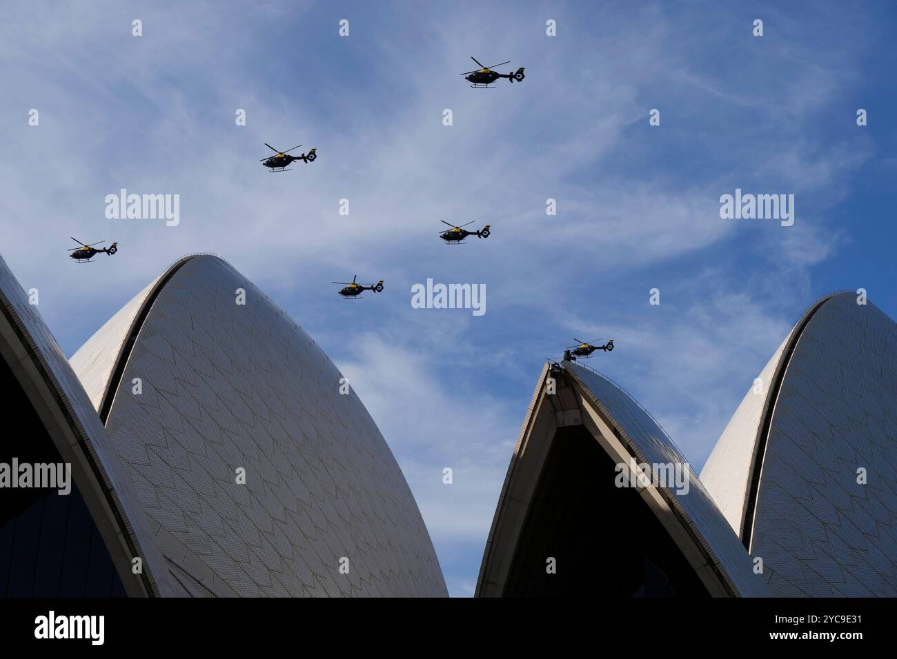 Military helicopters fly past the Sydney Opera House for Britain's King ...