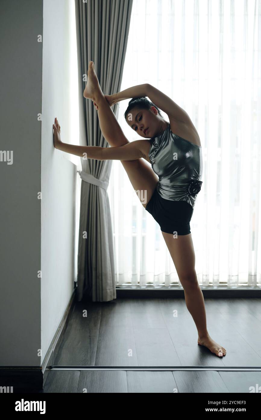 Ballet Dancer Stretching Near Window Before Routine Stock Photo - Alamy