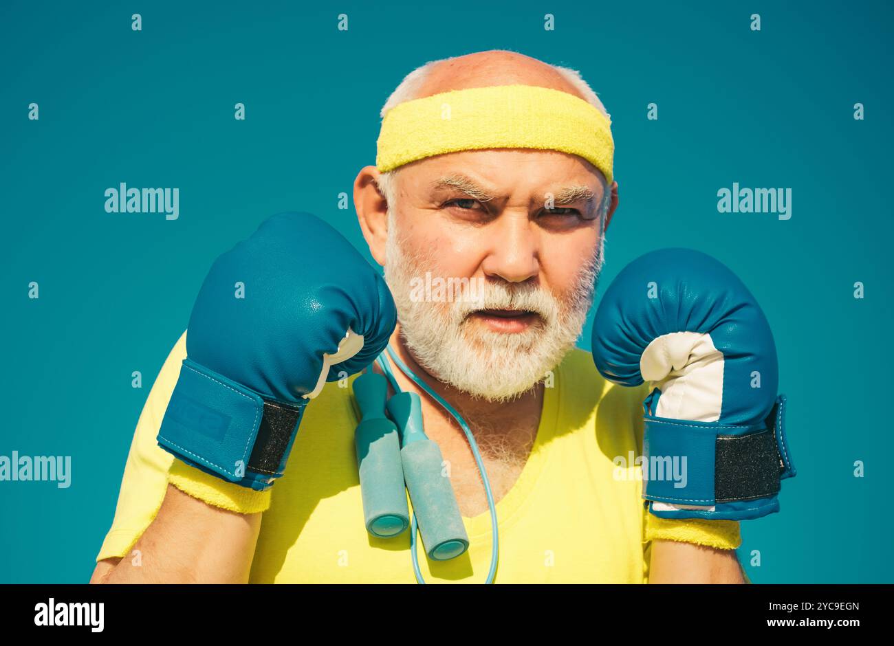 Funny bearded man standing in boxing pose. Elderly man hitting punching ...