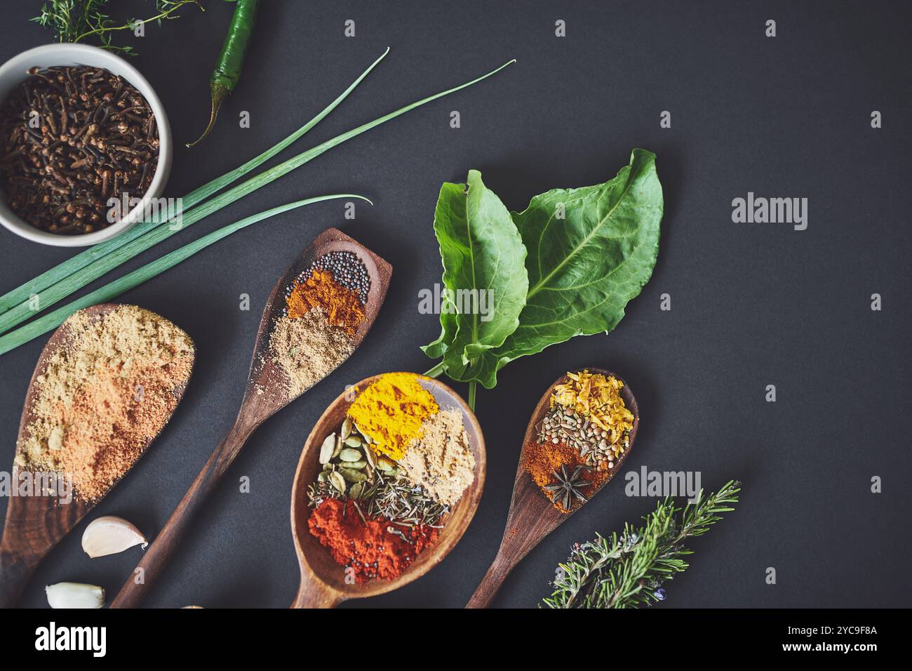 Kitchen, leaves and spices with spoon for culinary ingredients, flavor ...