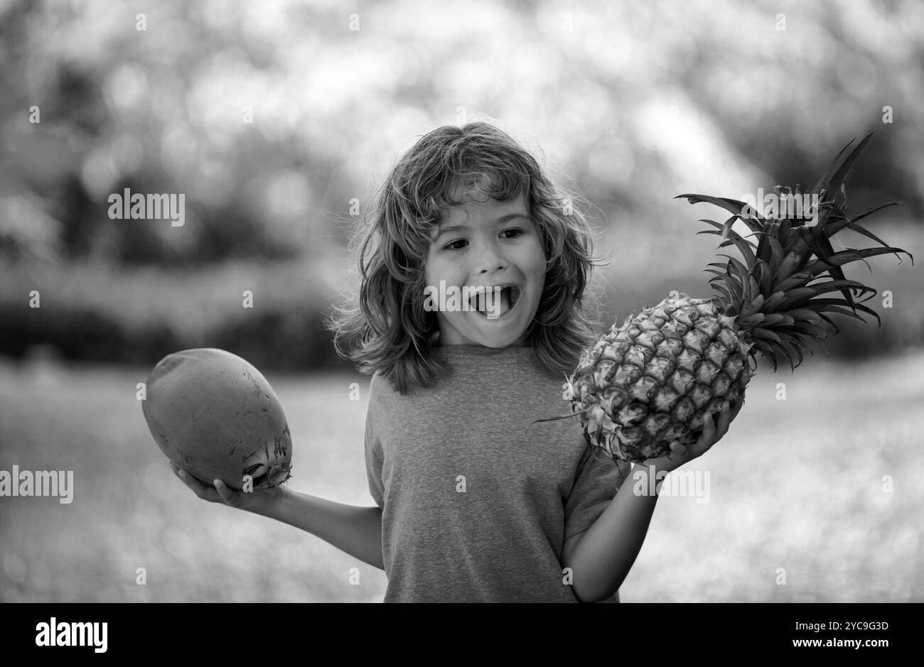 Little boy with pineapple and coconut. Kid with summer fruit Stock ...