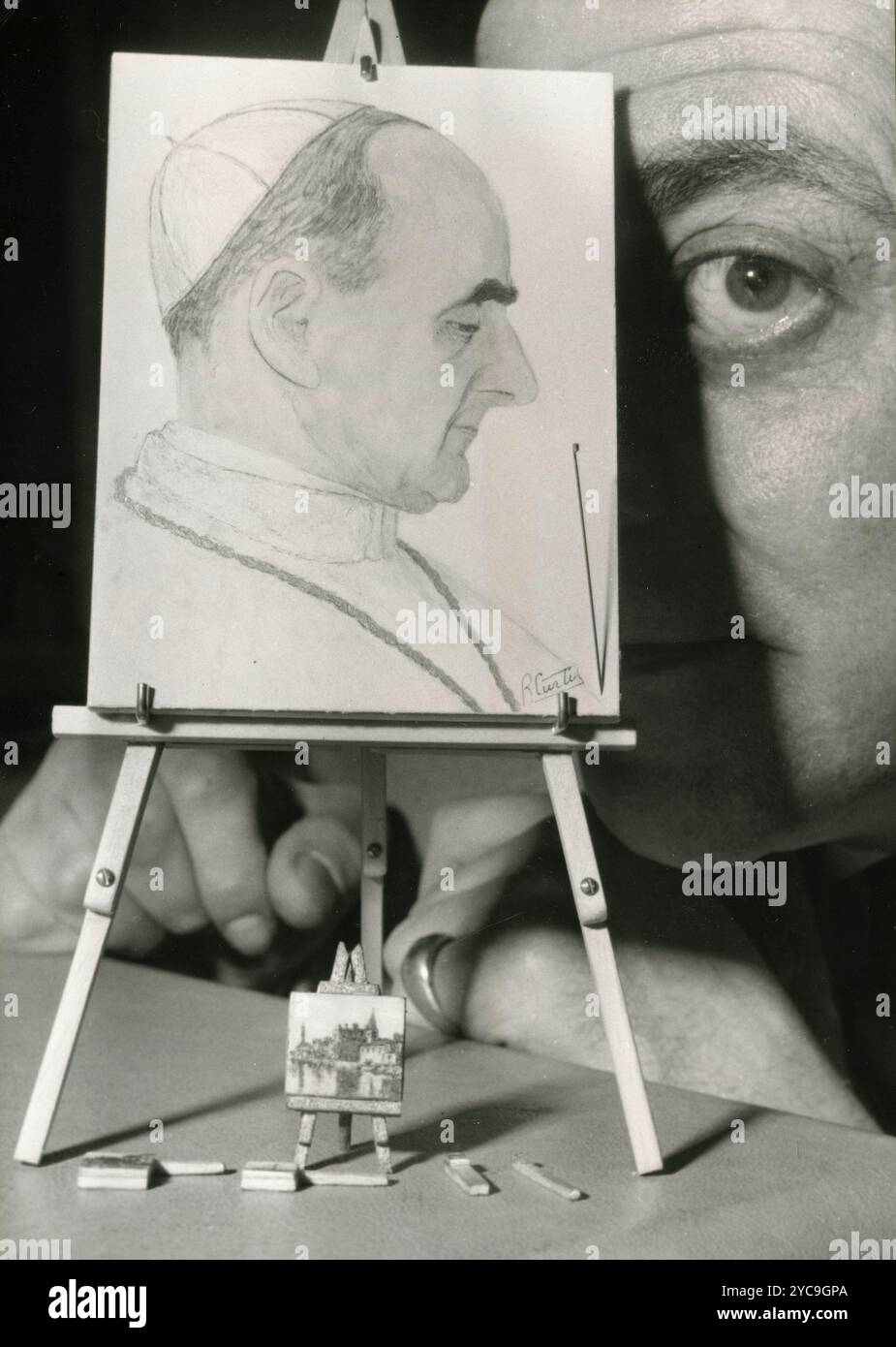 French artist Roger Curtiss showing some small painting portrait of ...