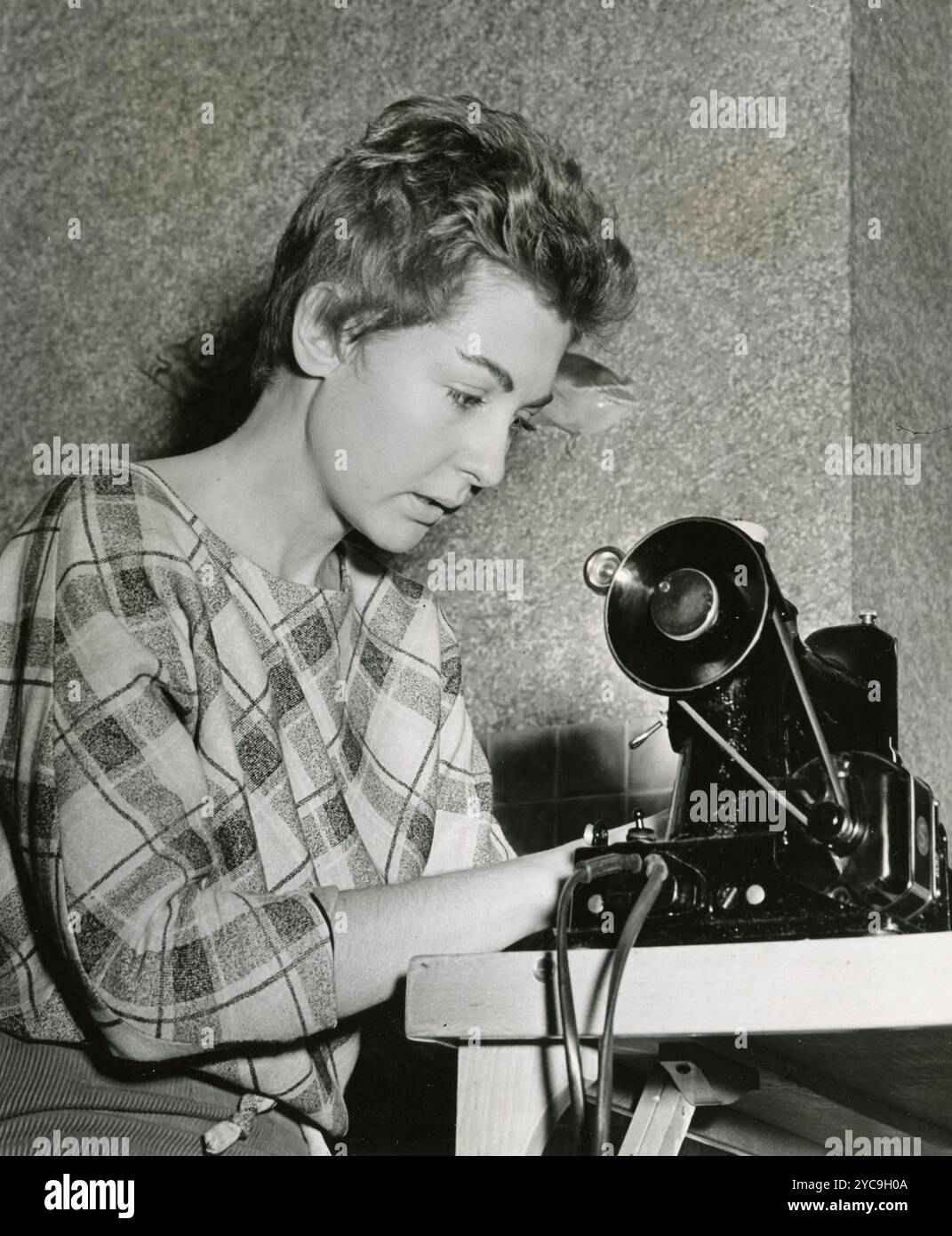Woman working at home with a sewing machine, 1960s Stock Photo - Alamy