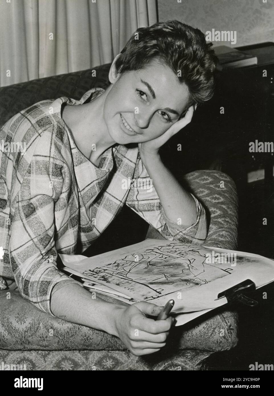 Woman artist drawing and smiling, 1960s Stock Photo - Alamy