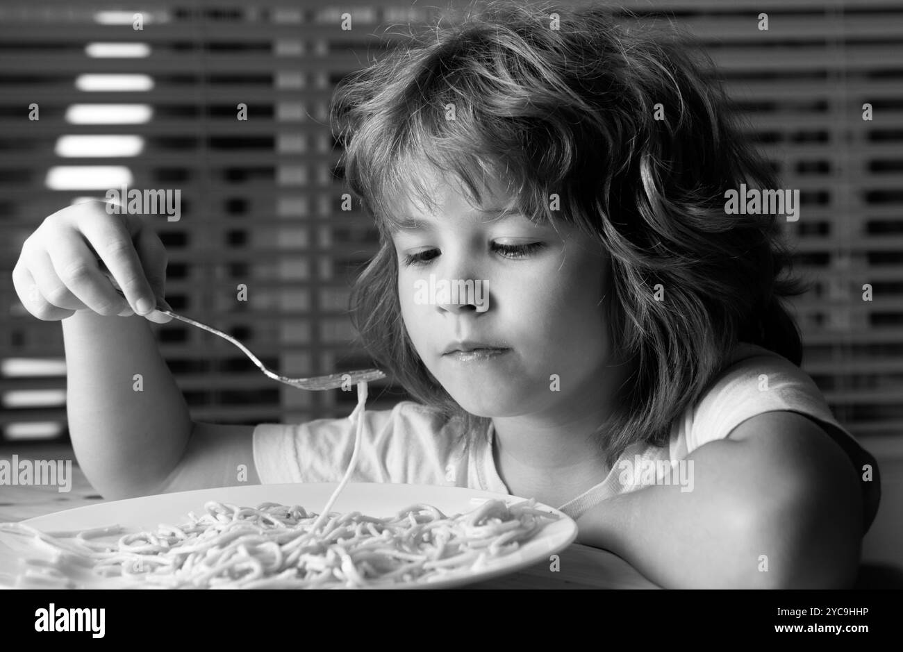 Portrait of little boy eating pasta, spaghetti. Concept of kids face ...