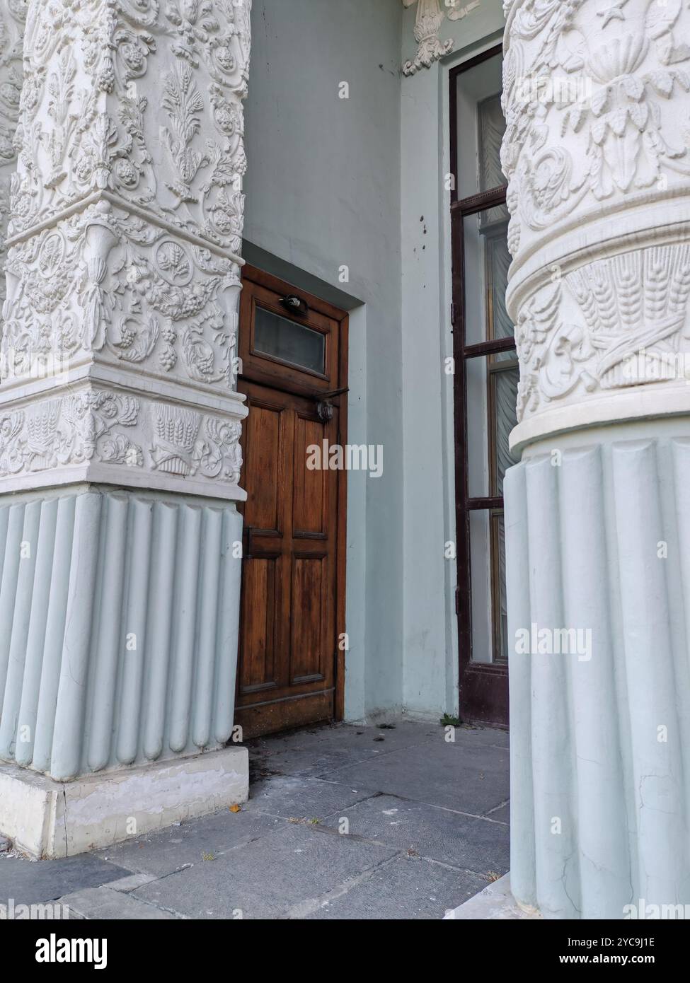 vintage-style wooden door and window combination framed by intricately ...