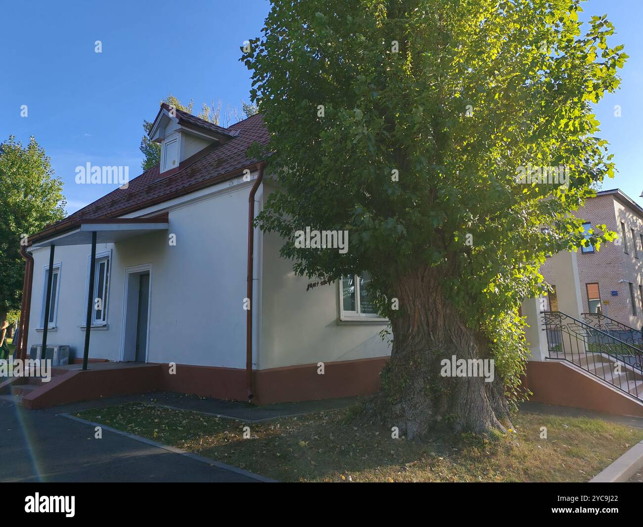 An old building with striking red brick pillars and a pitched roof ...