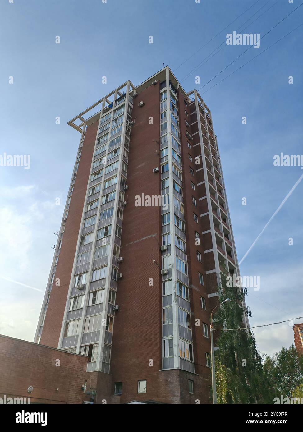 A high-rise residential building featuring a mix of red and beige brick ...