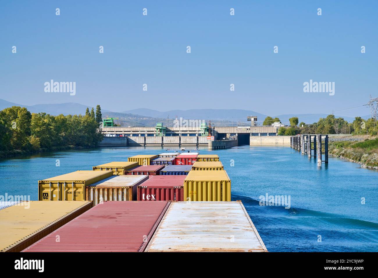Sablons (south-eastern France): barge, container ship going through the ...