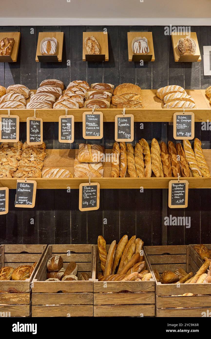 Various breads in a bakery: baguettes, traditional and speciality ...