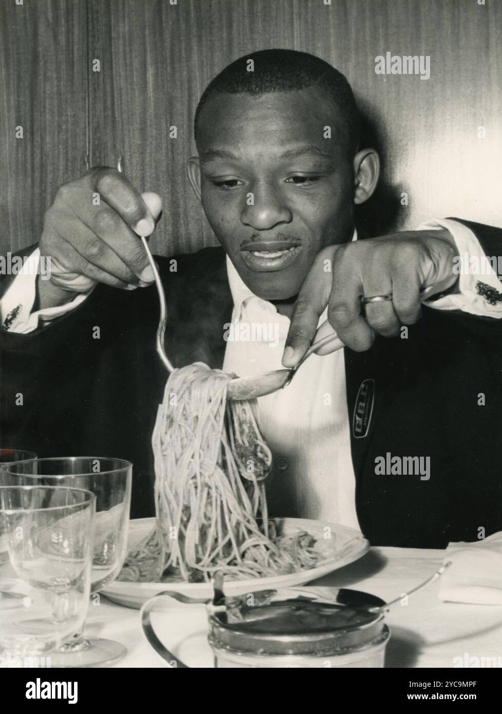 American professional boxer Eddie Perkins eating spaghetti, 1960s Stock ...