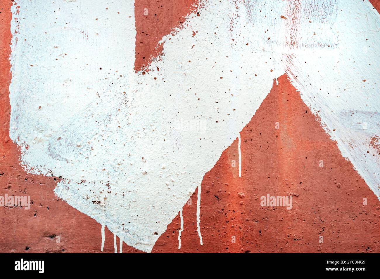 White paint spill and brush stroke on brown concrete wall as background ...